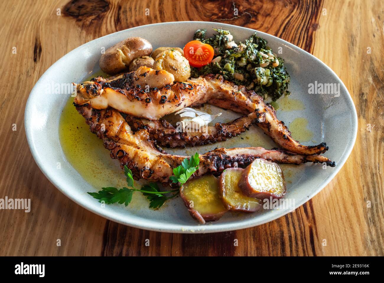 Popular portuguese grilled octopus plate with sweet potatoes and some ...