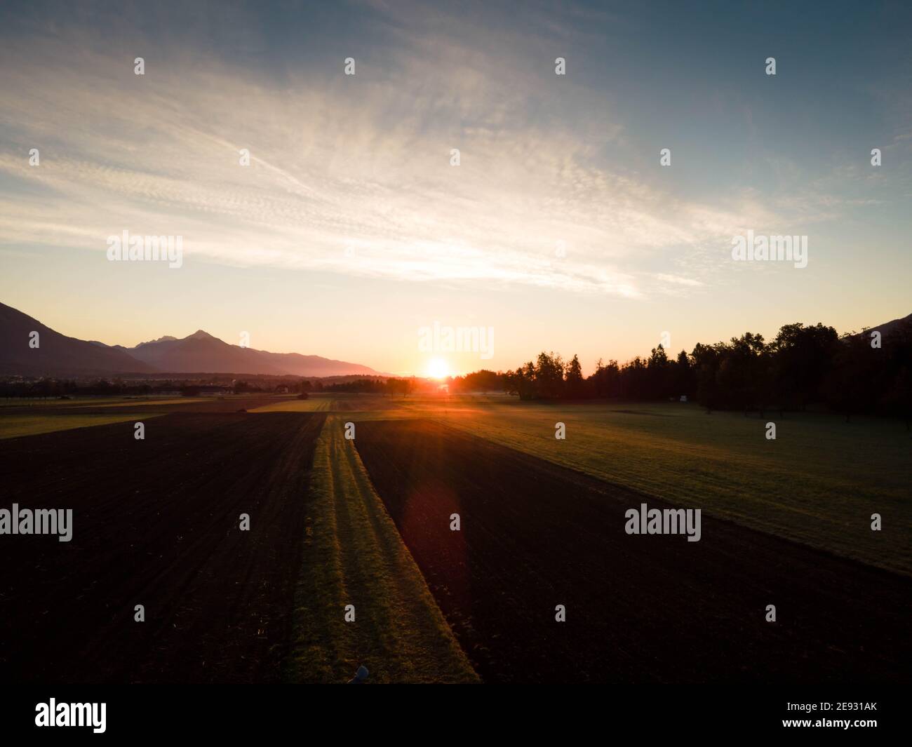 Sun set in a forest mountain and winter landscape hi-res stock ...