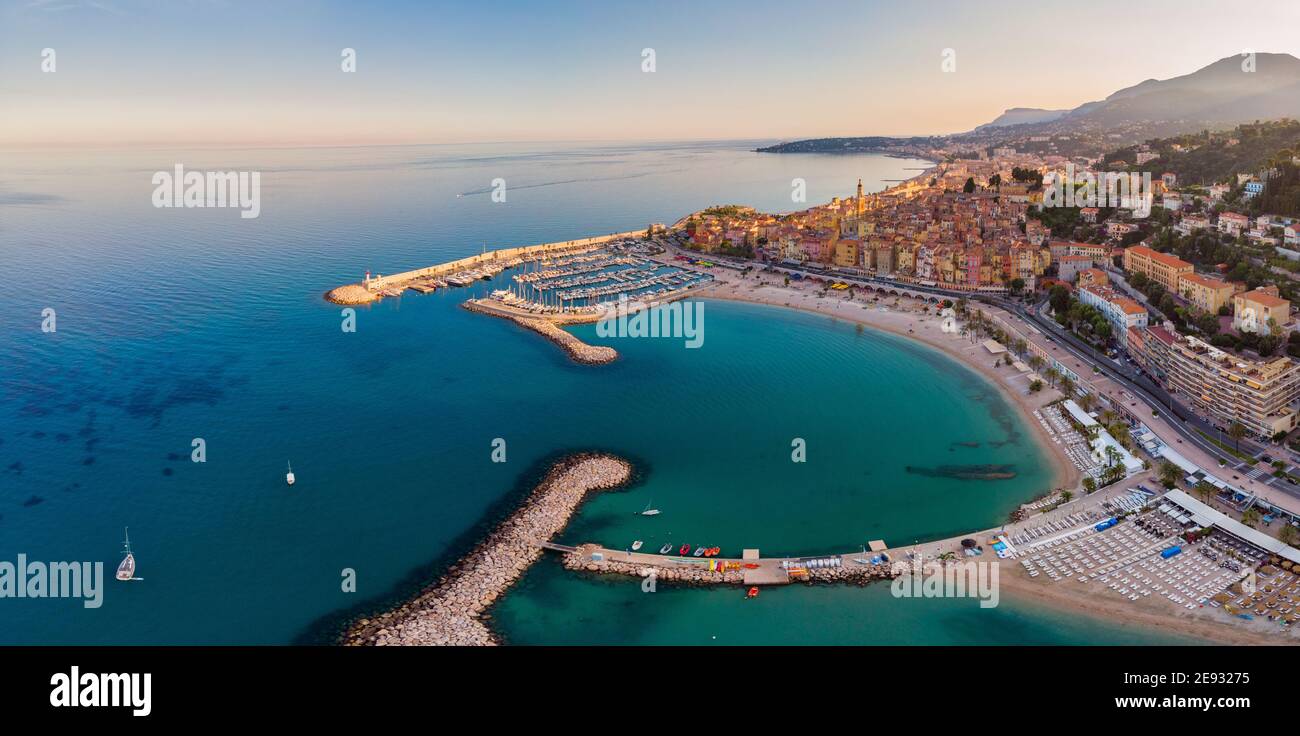 Sand beach beneath the colorful old town Menton on french Riviera ...