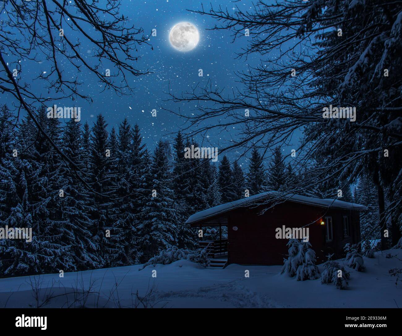 wooden cottage in winter landscape by night with full moon and stars ...