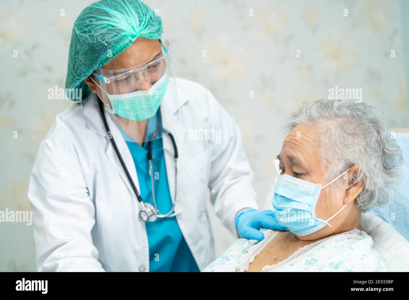 Asian doctor wearing face shield and PPE suit new normal to check ...