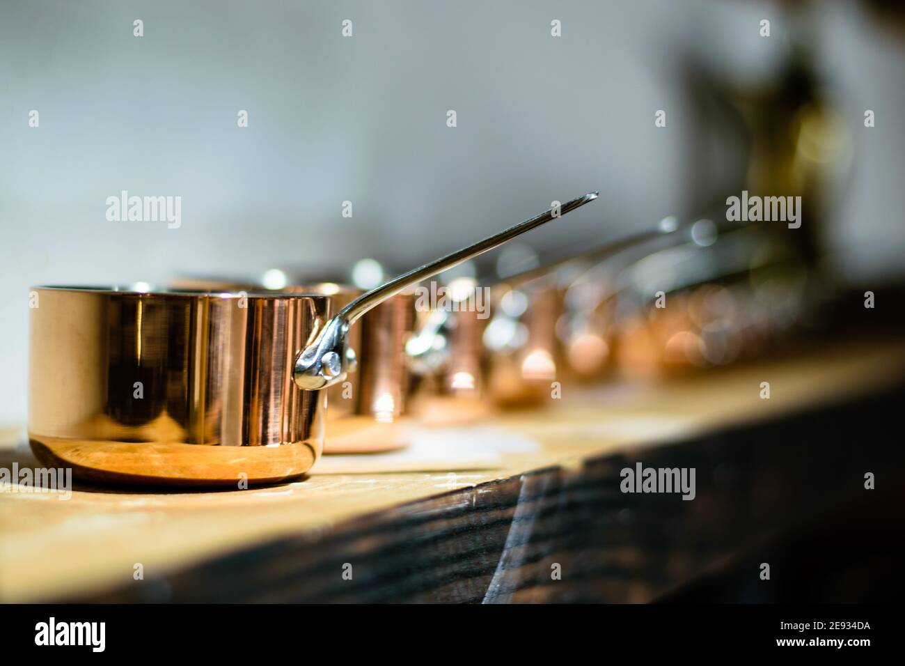Small copper pots on a wooden ledge at a restaurant Stock Photo - Alamy