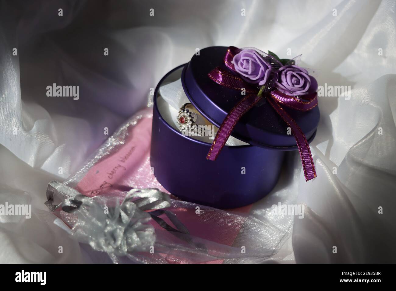 Silver Diamond ruby engagement ring in Purple open box with flowers and ...