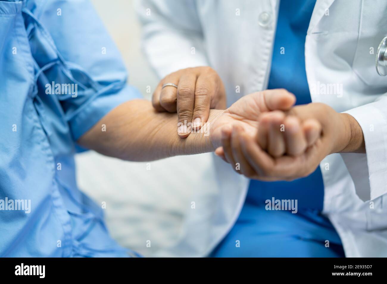Doctor catch the pulse with patient in nursing hospital ward, healthy ...