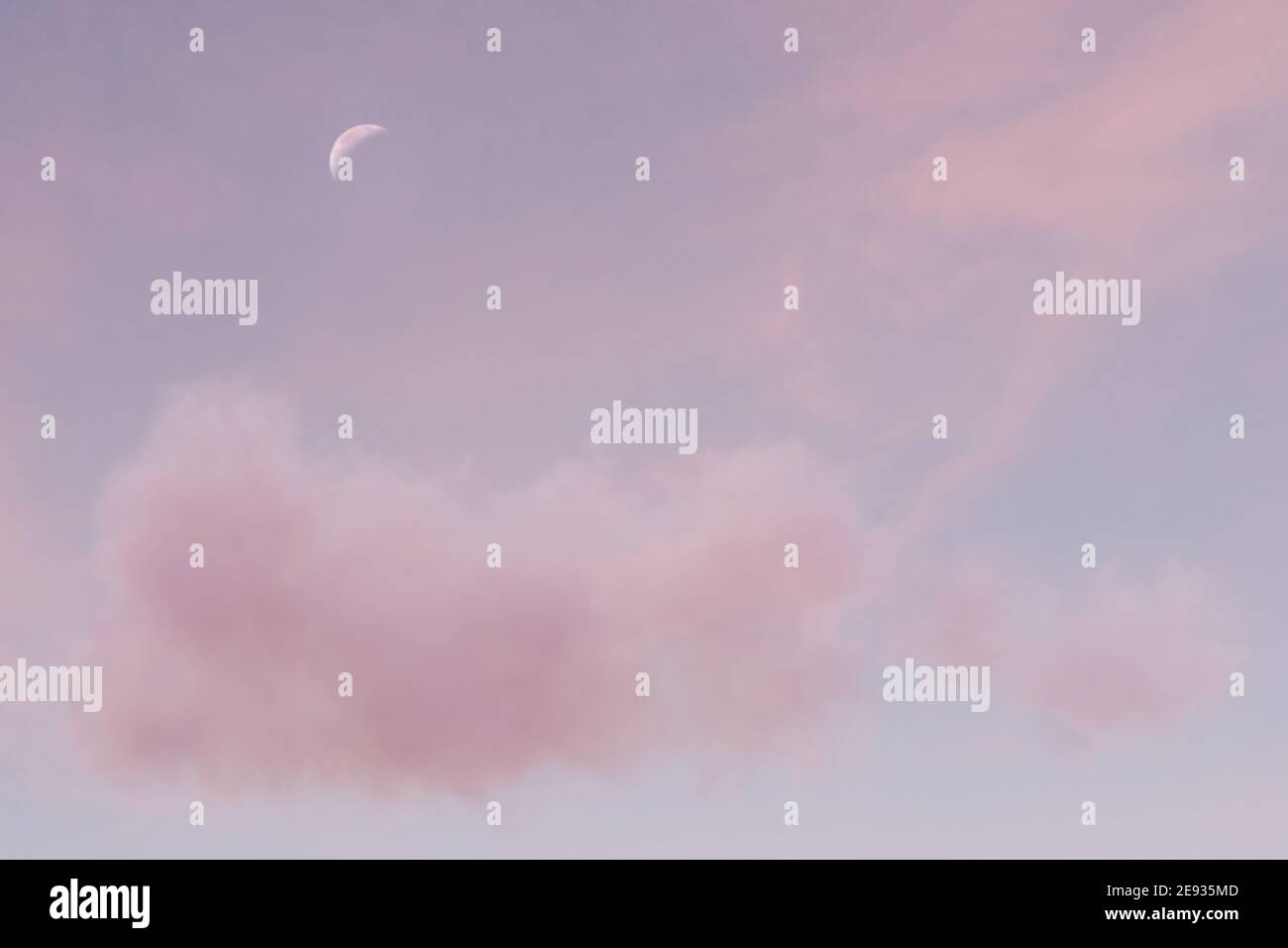 soft purple sky with fluffy clouds and crescent moon Stock Photo - Alamy