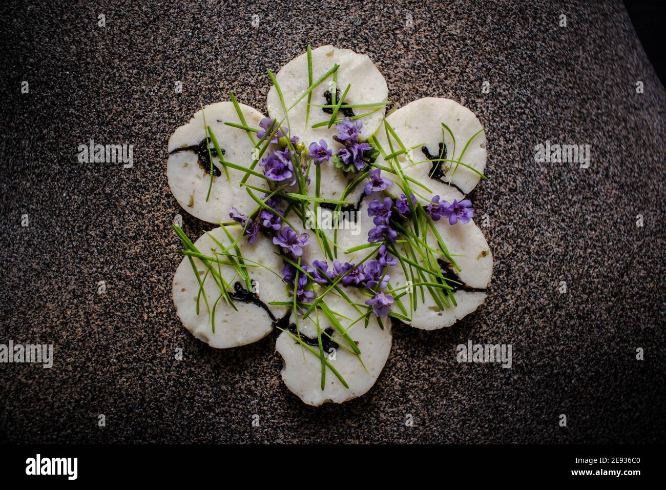 Fish roulade on an interesting plate decorated with fir needles at a ...