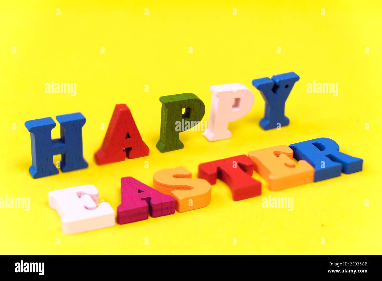 Words Happy Easter of colorful toy alphabet letters isolated on yellow ...
