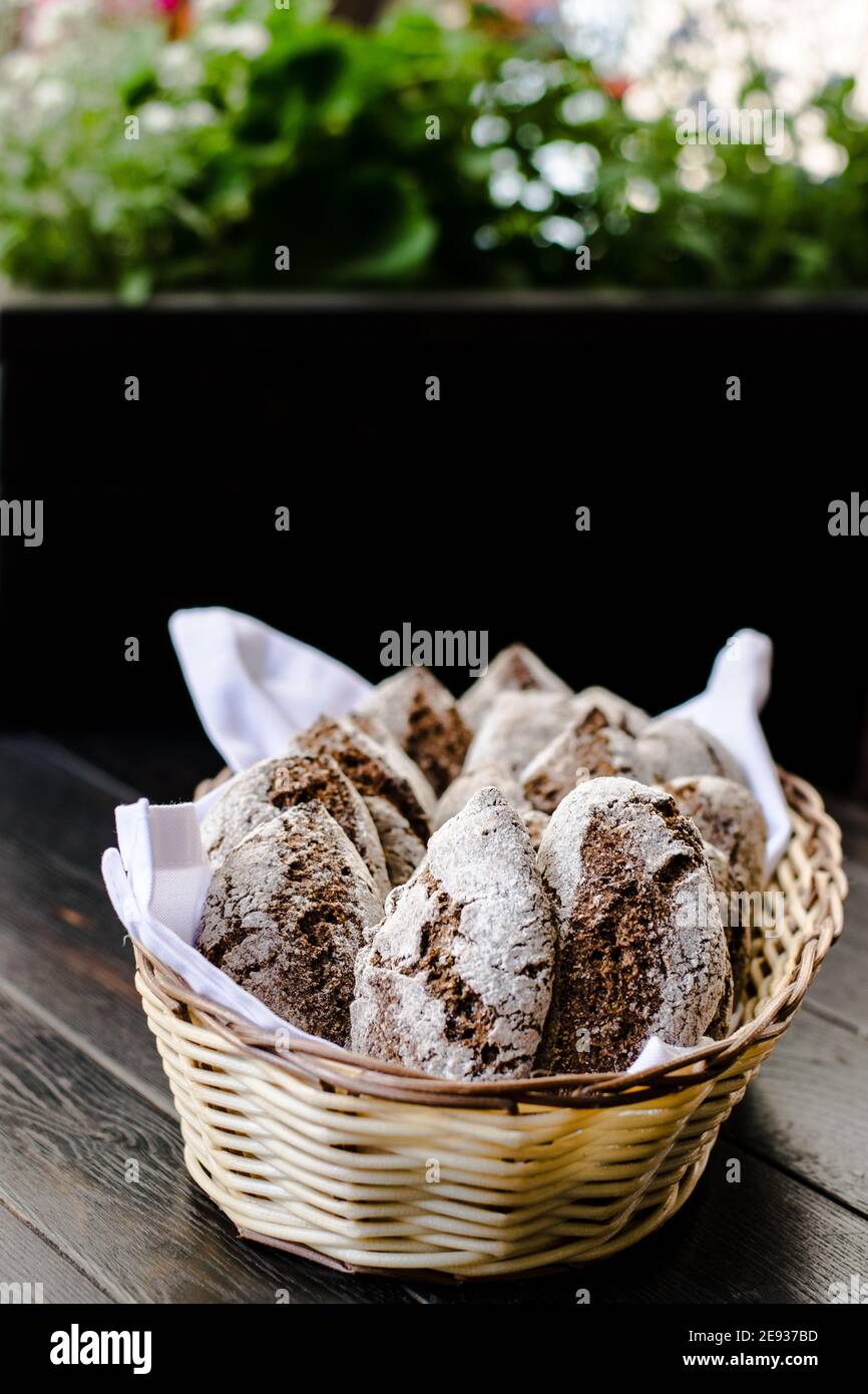 Small rye bread loafs in a basket at a restaurant Stock Photo - Alamy