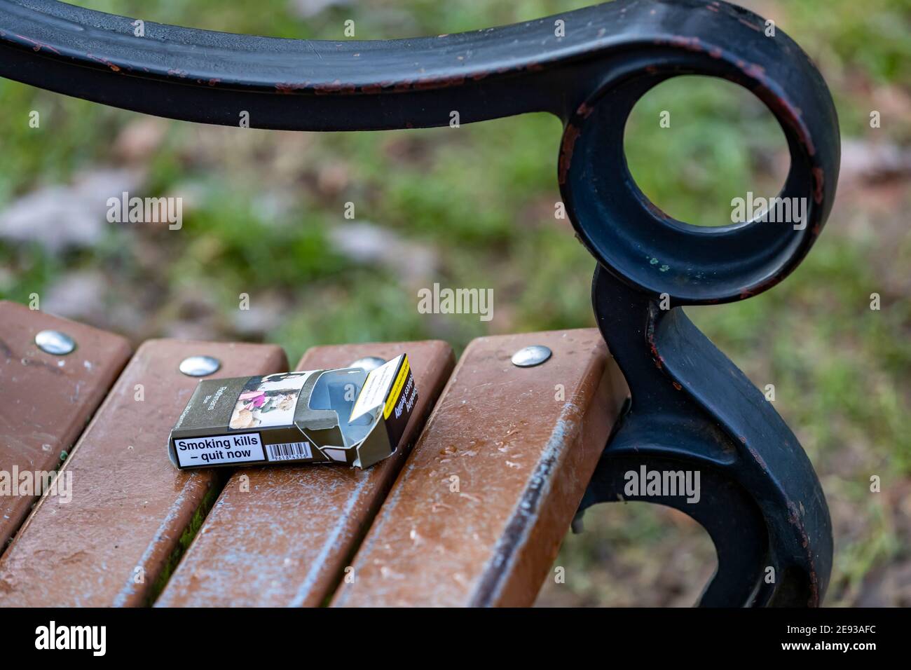 Empty cigarette packet of Rothmans Blue left on a park bench insteading ...