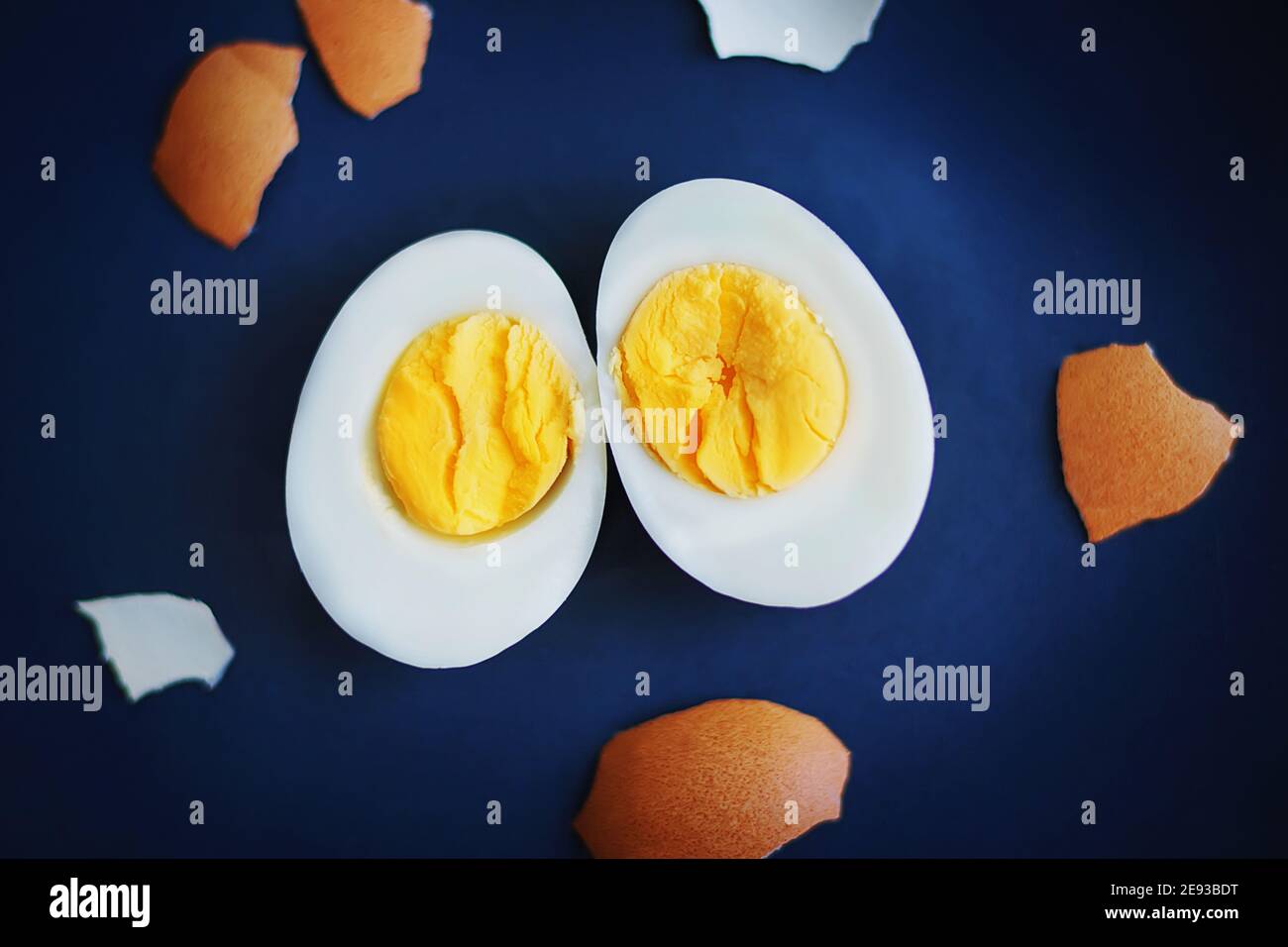 On a blue background lie the remains of a broken shell and two halves ...