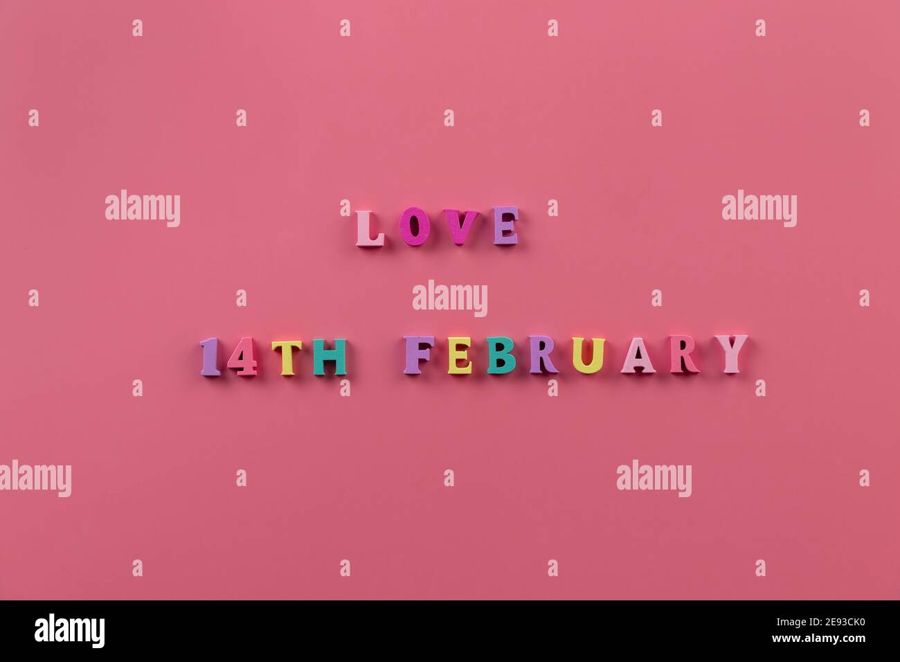 The word "LOVE 14th February" banner. Multicolored letters on pink ...