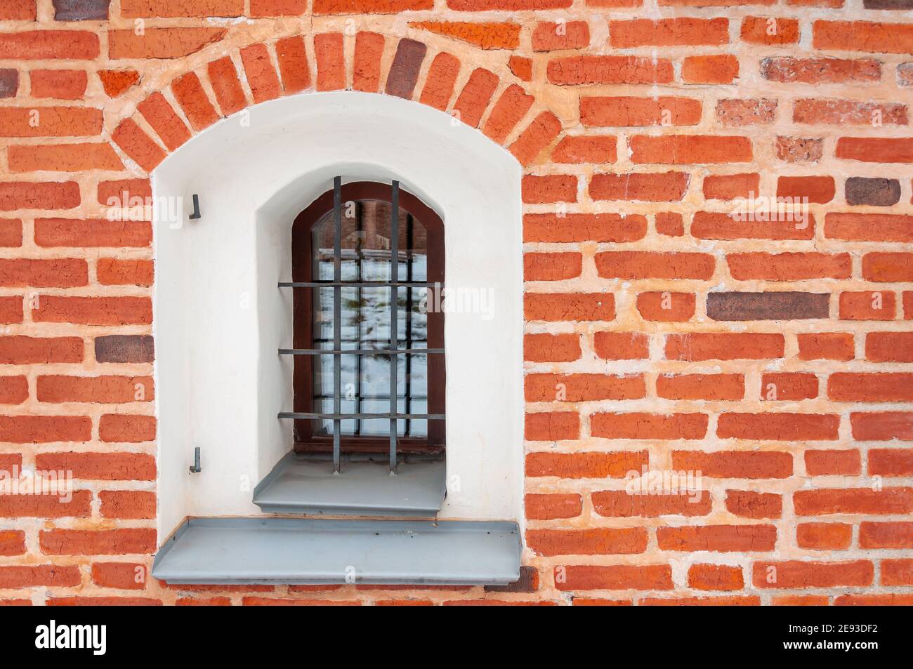 Window with lattice and gray sill. Part of an old building with red ...