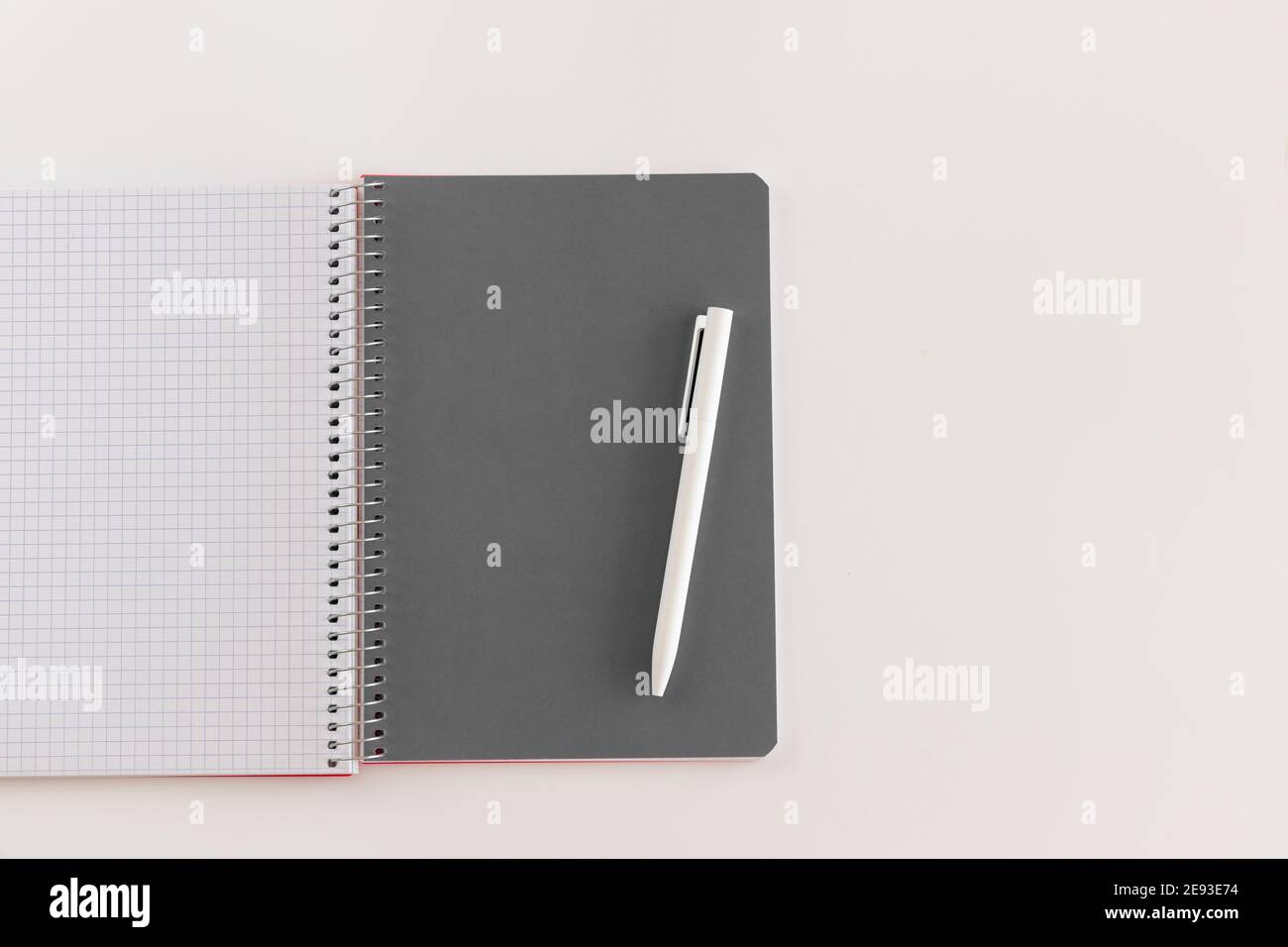 Spiral opened notebook with gray sheet and white pen. Layout and flat ...
