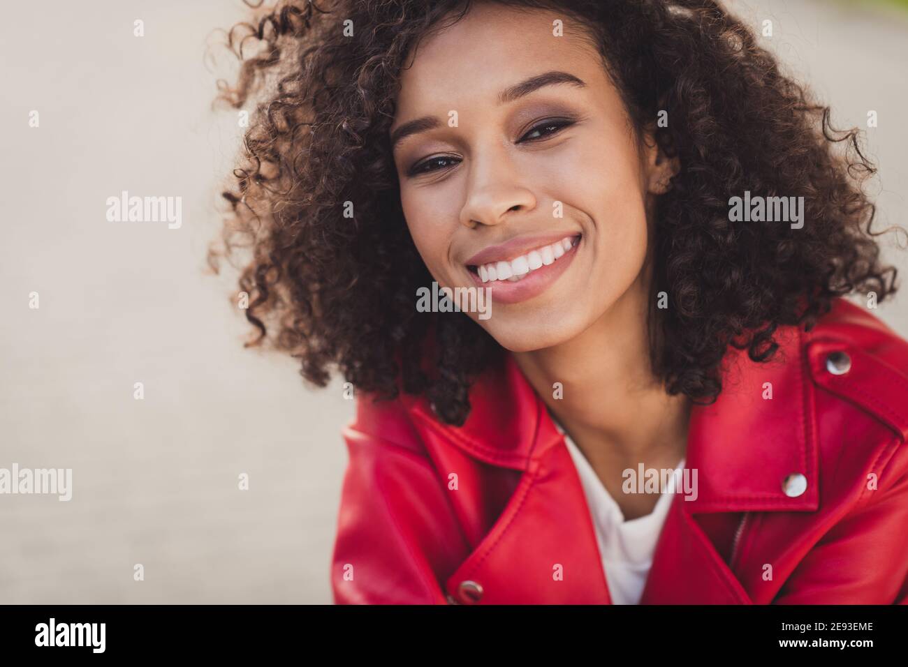 Photo Of Adorable Sweet Pretty Curly Woman Dressed Red Jacked Positive