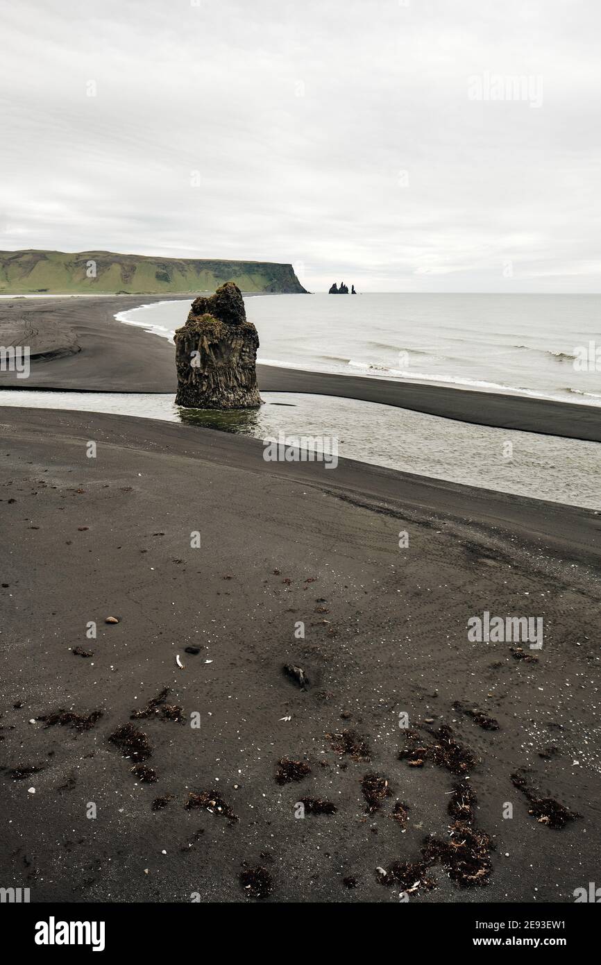 The black sand beach and Arnardrangur basalt sea stack at Dyrhólaey ...