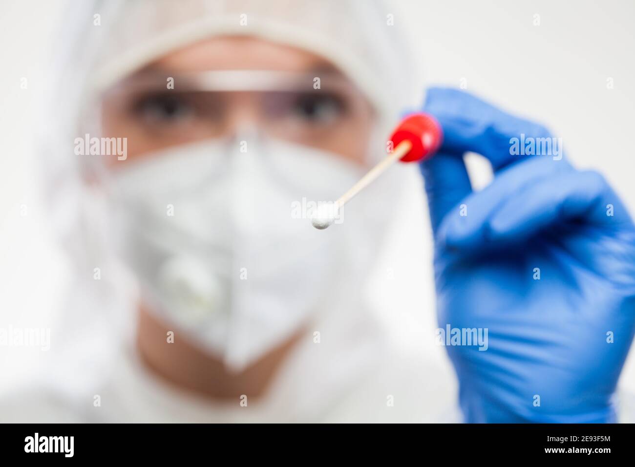 Medical NHS worker in personal protective equipment holding Coronavirus ...