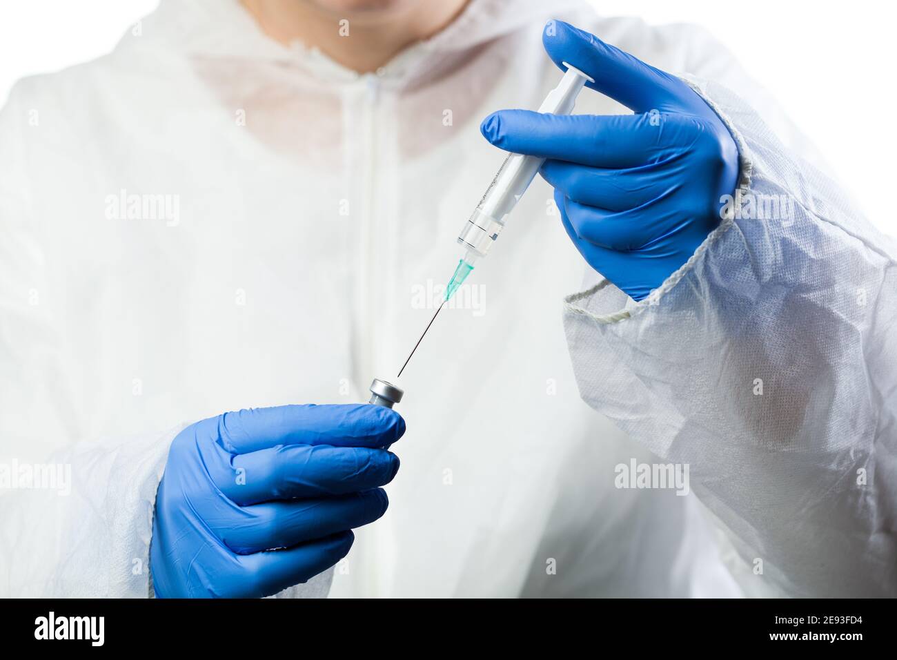 Medical lab technician inserting syringe needle into bottle ampoule ...