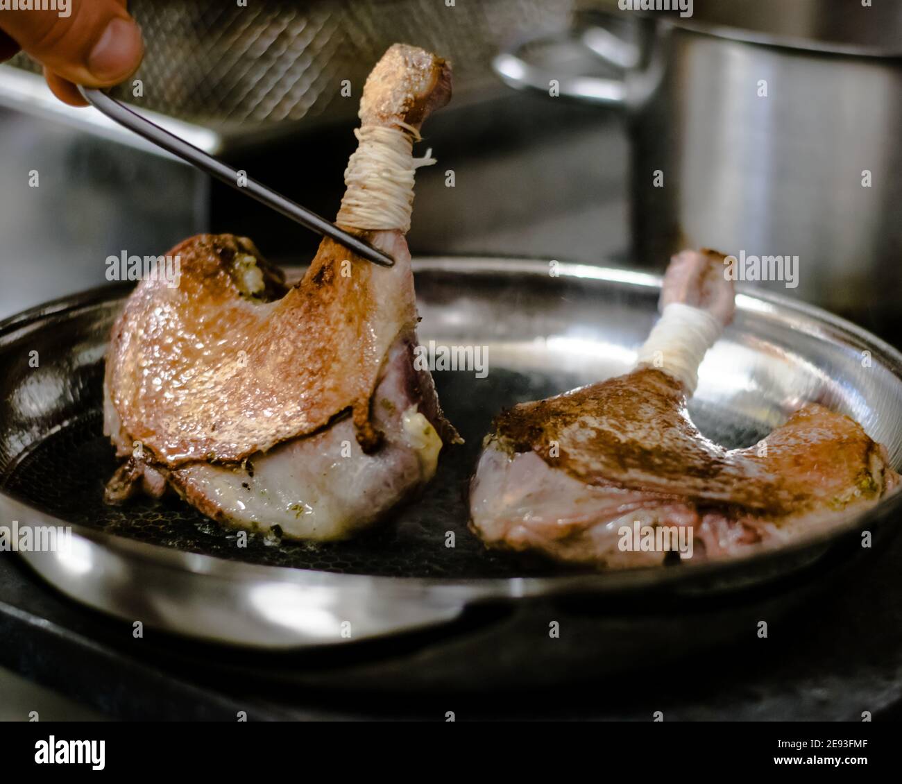 Chef preparing quail in a pan at a restaurant Stock Photo - Alamy