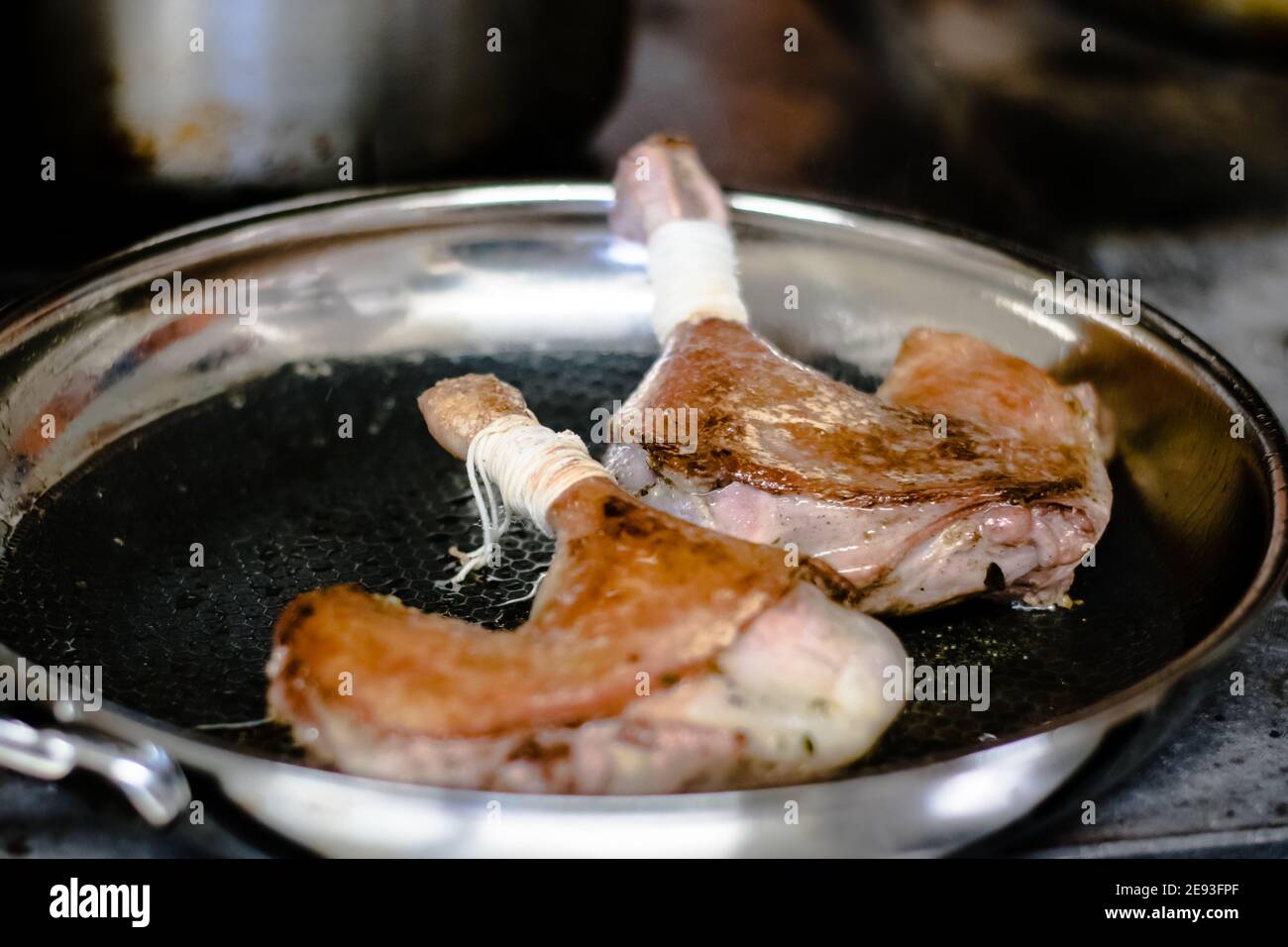 Chef preparing quail in a pan at a restaurant Stock Photo - Alamy