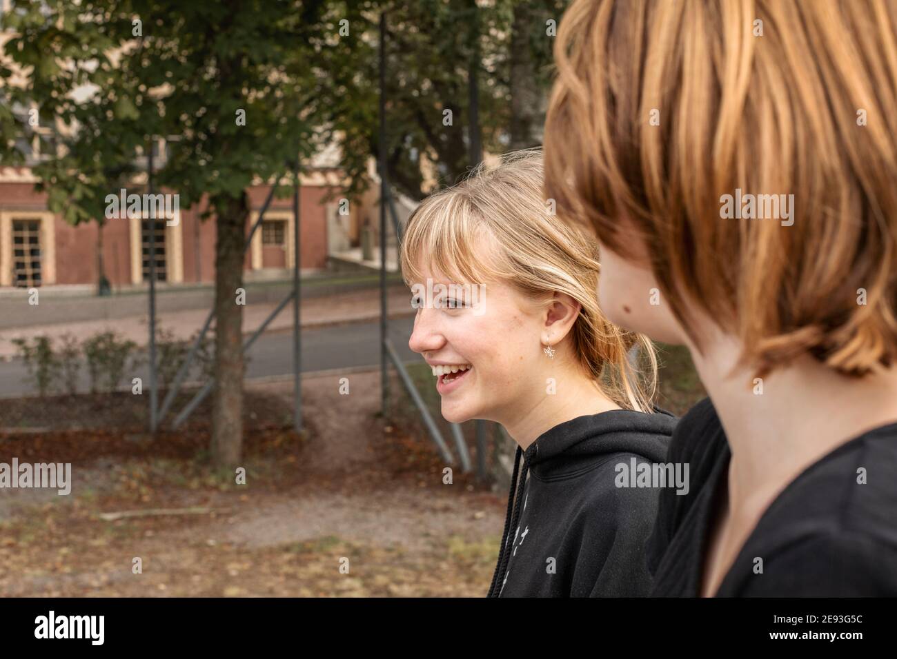 Smiling teenage girls talking Stock Photo - Alamy