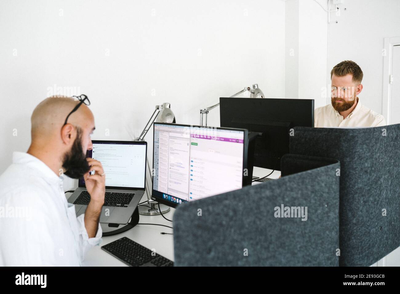 Men working on computers in office Stock Photo - Alamy