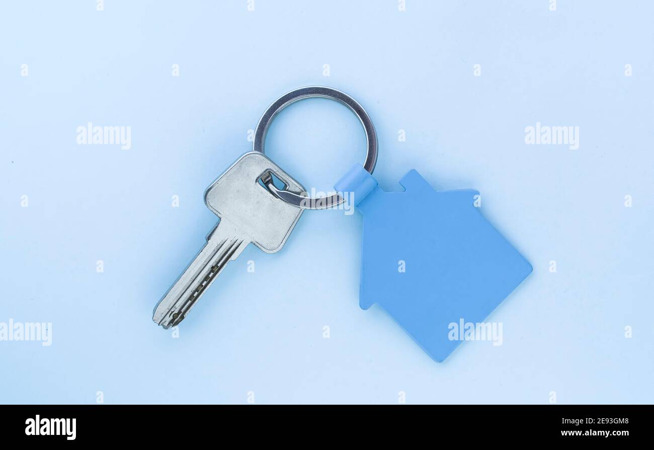 key chain with house symbol and keys on green background,Real estate ...