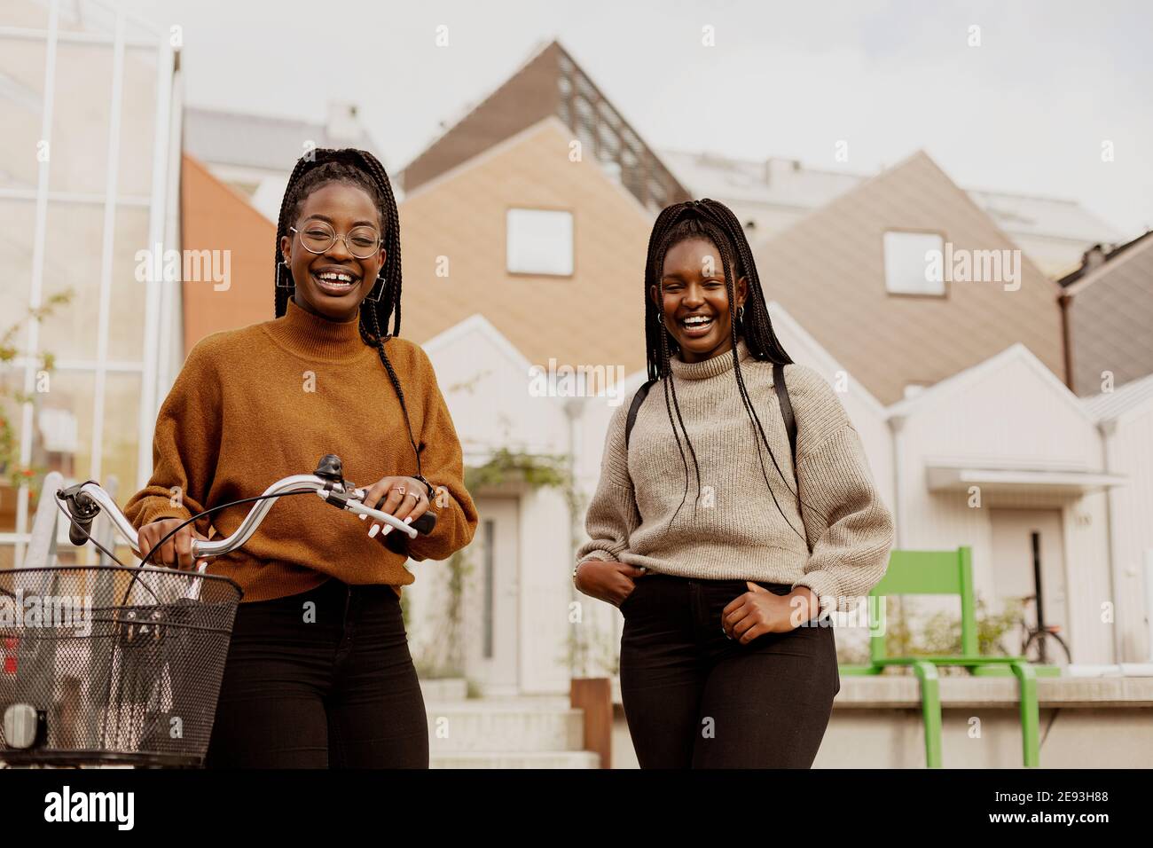 Happy female friends looking at camera Stock Photo - Alamy