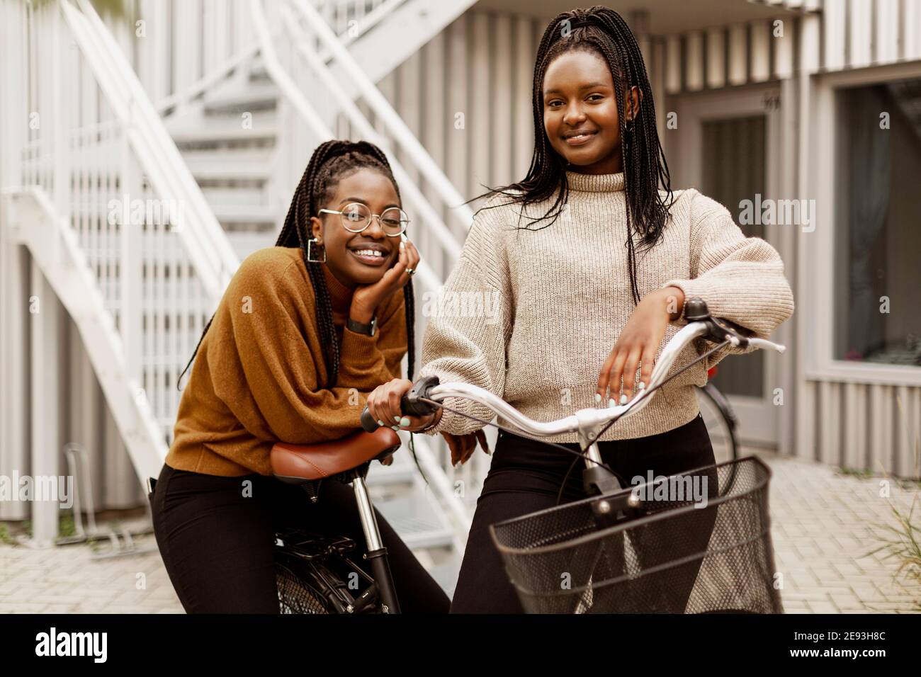 Happy female friends looking at camera Stock Photo - Alamy