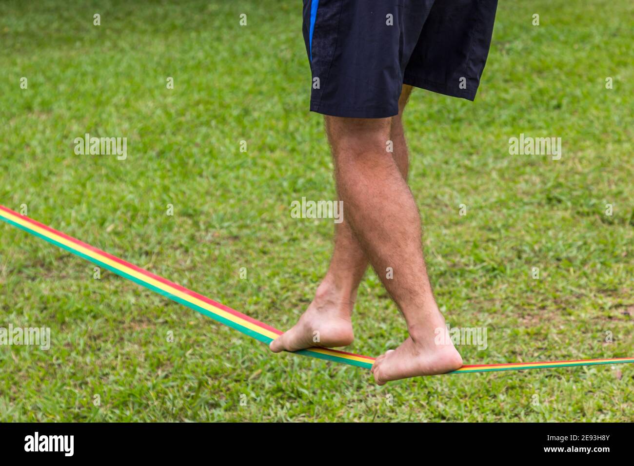 Legs of a person Slacklining on the grass Stock Photo - Alamy