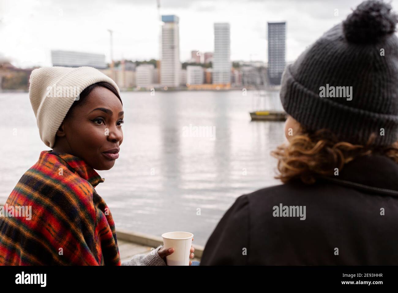 Female friends talking at sea Stock Photo - Alamy