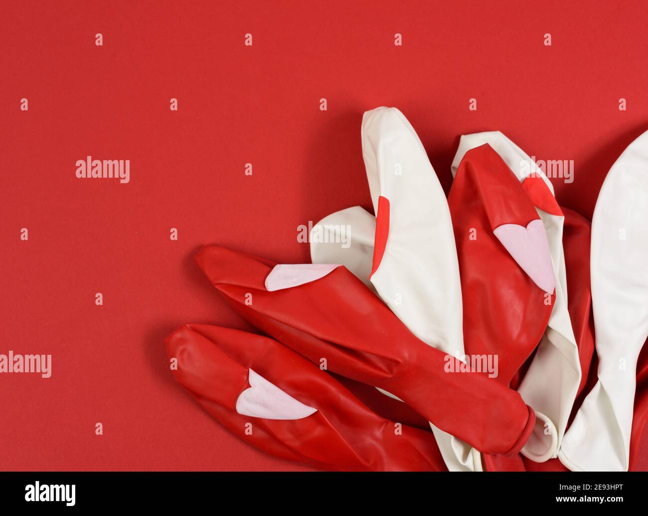 deflated red and white balloons on a red background, top view Stock ...