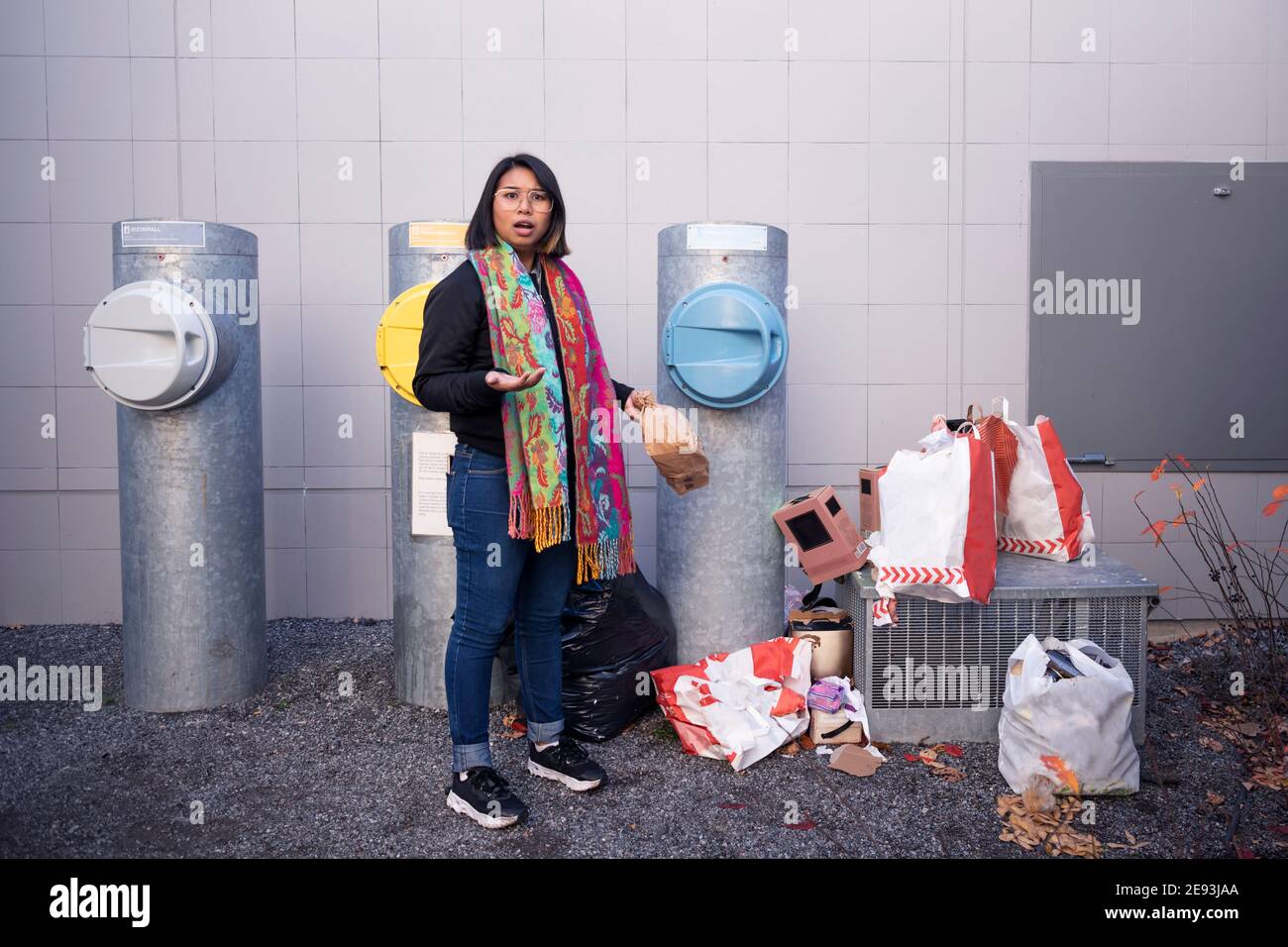 Woman in front of recycling bins Stock Photo - Alamy