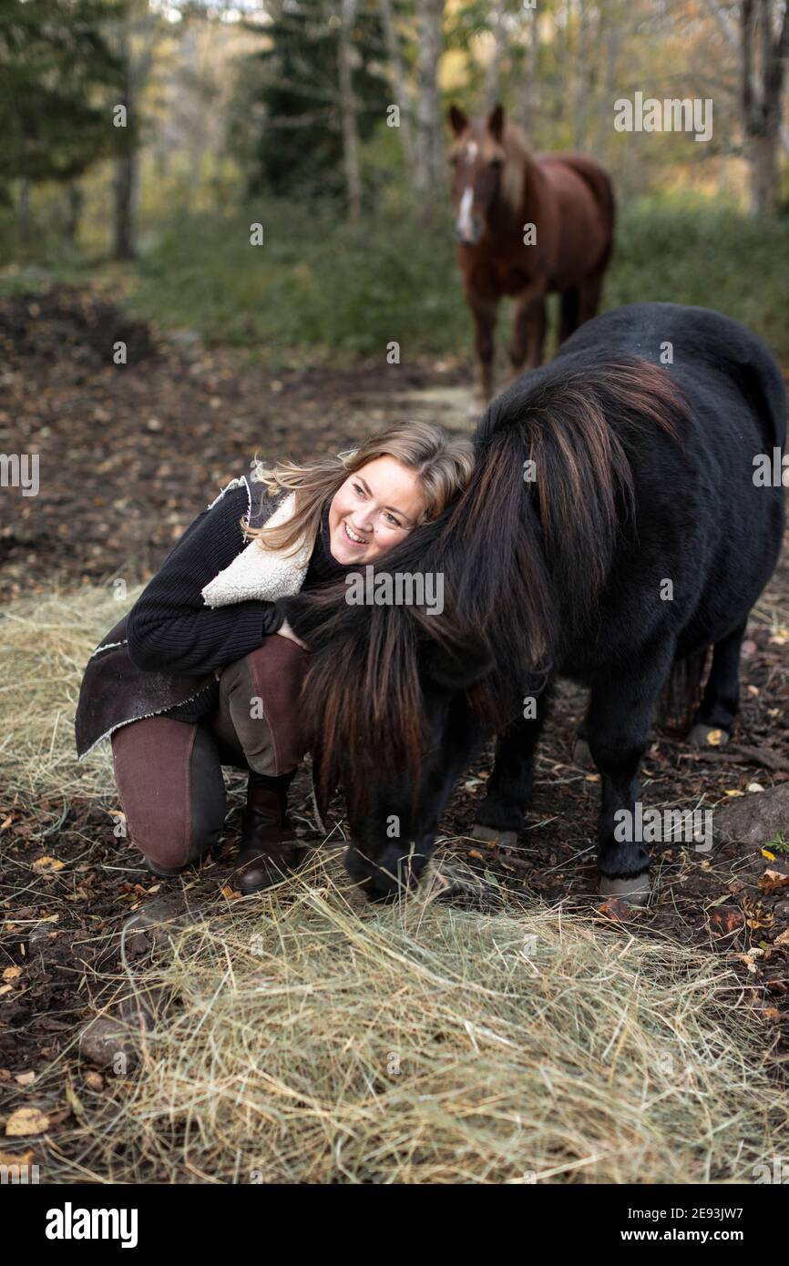 Woman feeding horses hi-res stock photography and images - Alamy