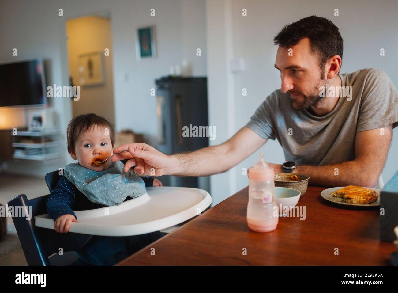 Father feeding baby Stock Photo - Alamy