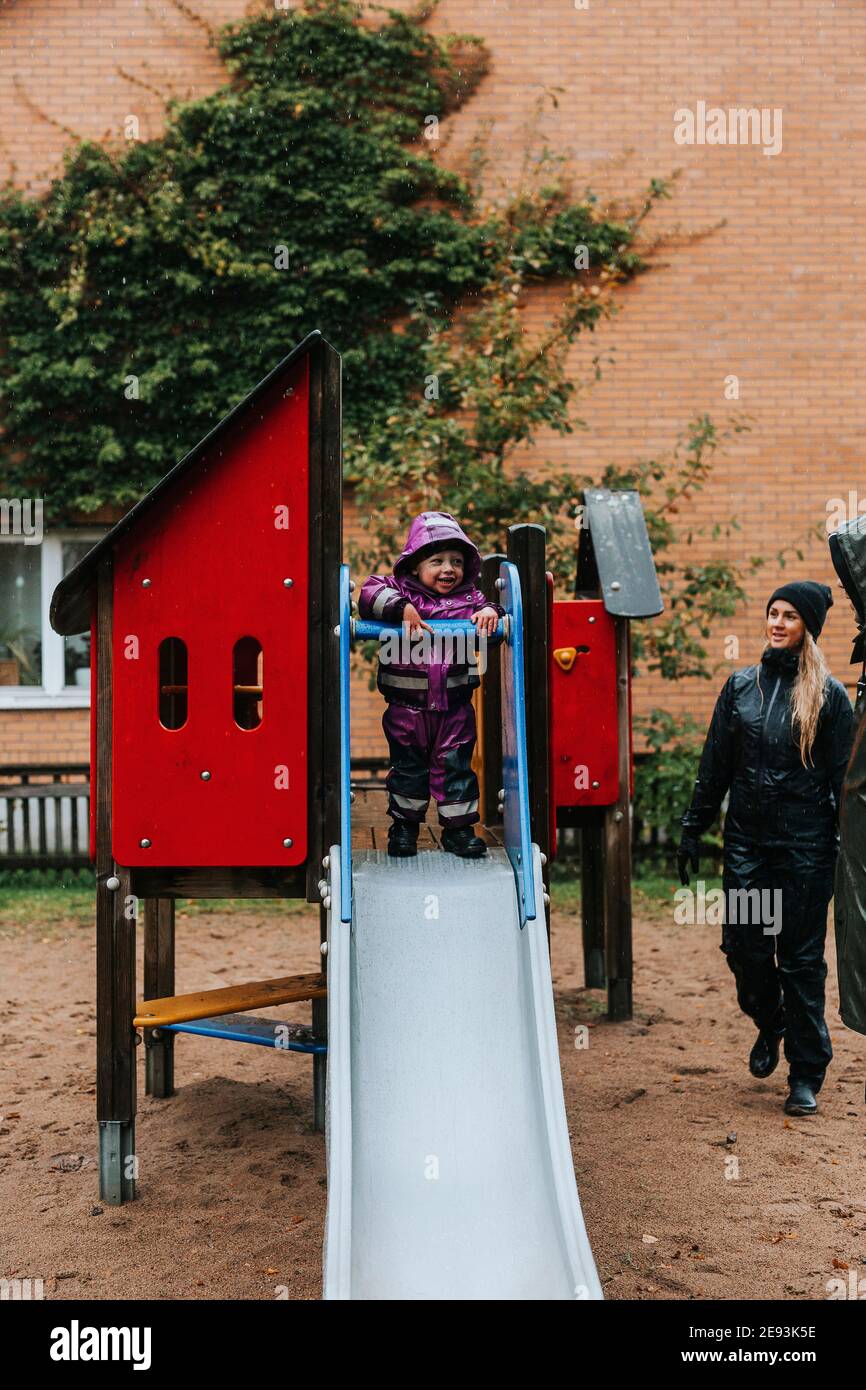 Children standing on playground slide hi-res stock photography and ...