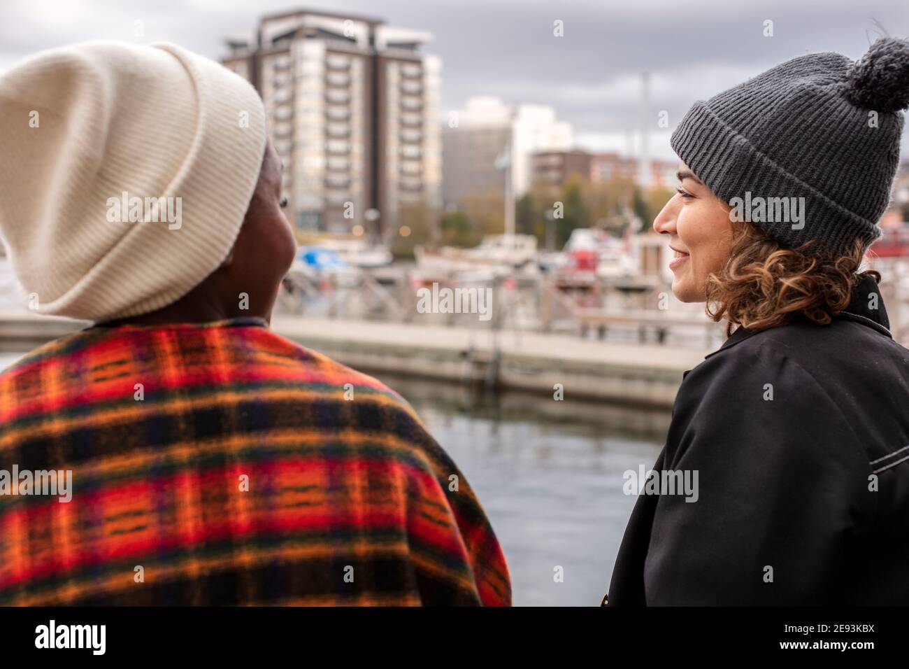Female friends talking at sea Stock Photo - Alamy