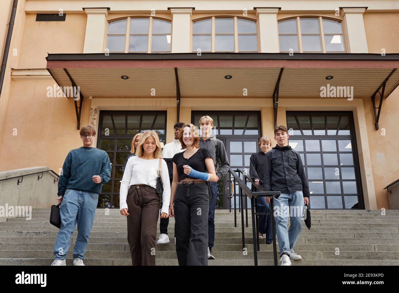Teenagers in front of school Stock Photo - Alamy