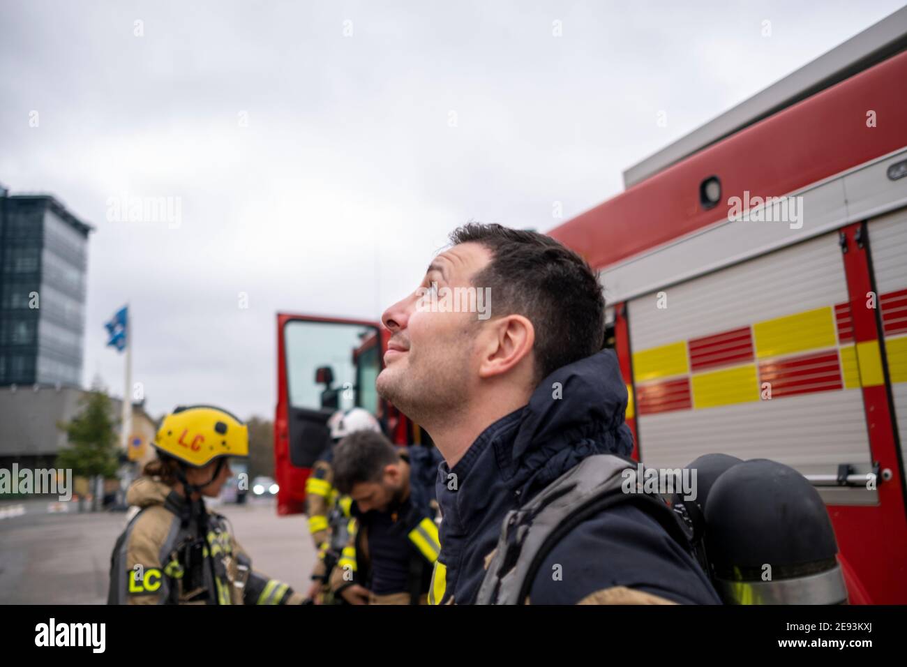 Male firefighter looking away Stock Photo - Alamy