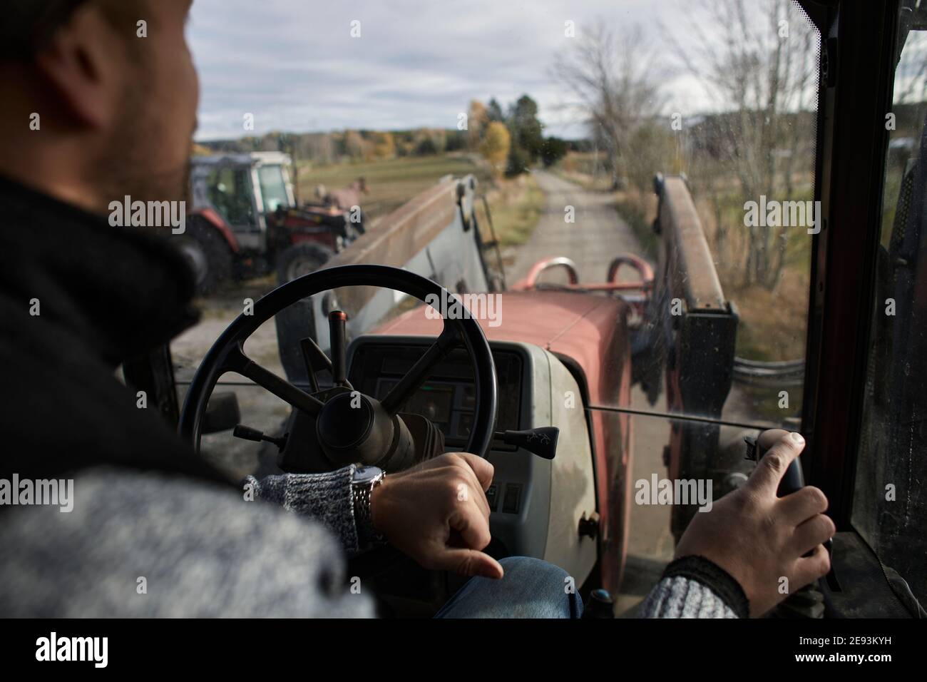 Farmer driving tractor Stock Photo - Alamy