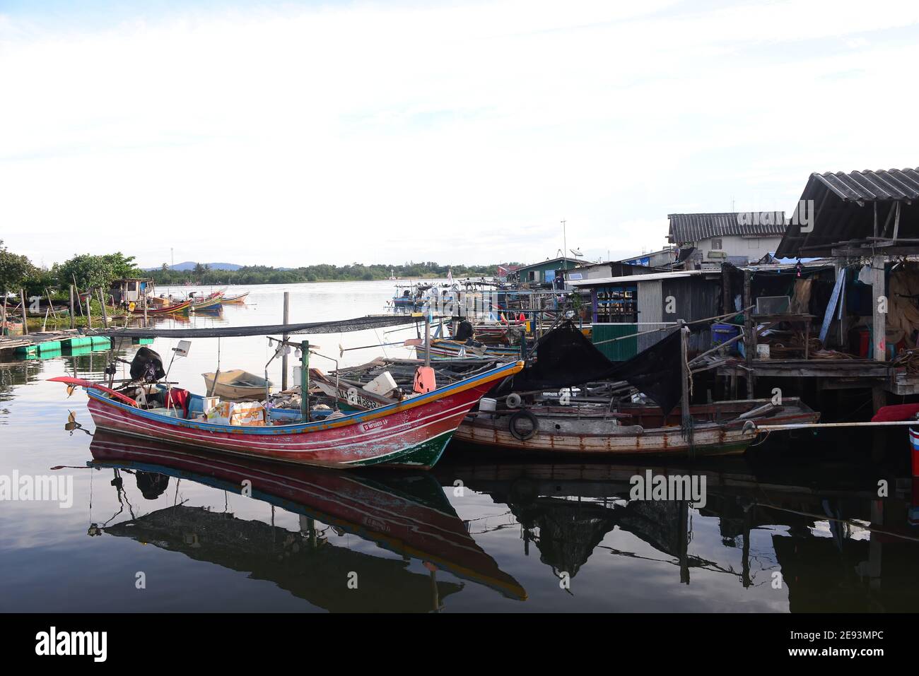 NARATHIWAT, THAILAND – 1 JANUARY 2021 : Local fishing village along the Bang Nara River with ...