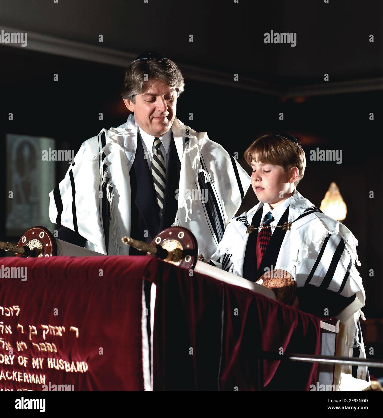Judaism; Barmitzvah boy weekday reading of the Torah watched by his ...
