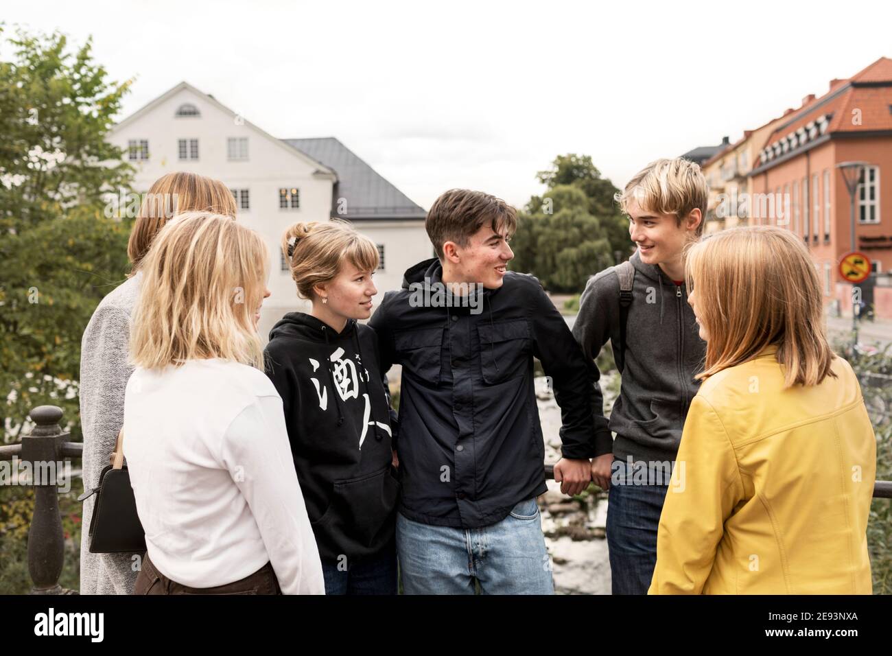 Smiling teenagers talking Stock Photo - Alamy