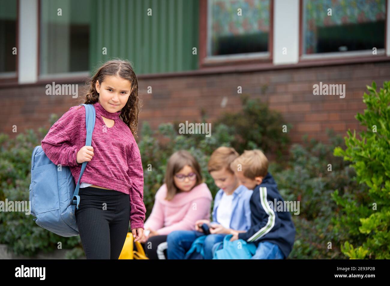 Girl with backpack in front of school Stock Photo - Alamy