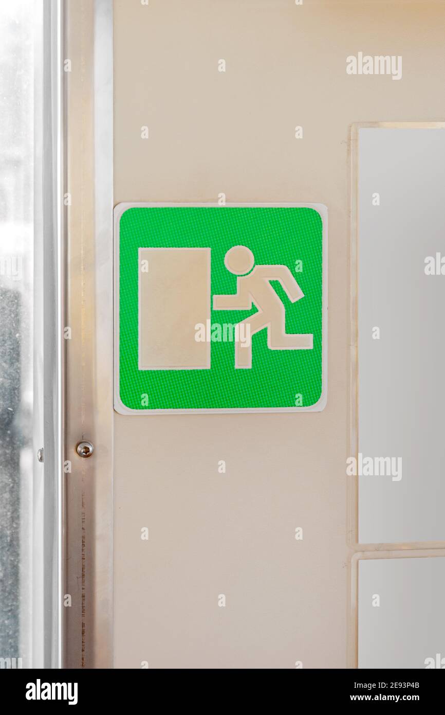 Glow in the Dark Emergency Exit Sign at Wall Stock Photo - Alamy