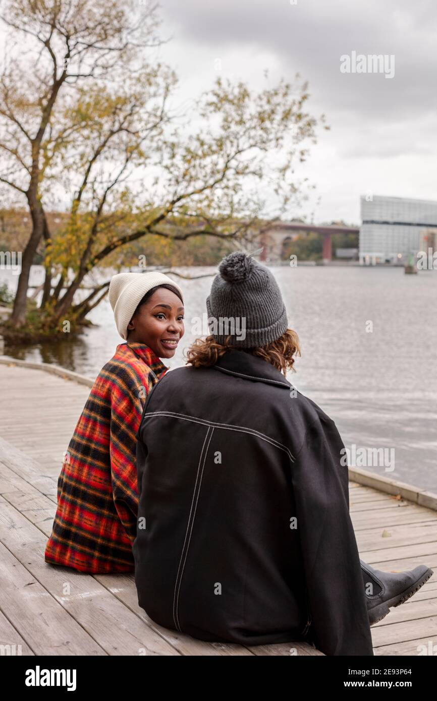 Female friends talking at sea Stock Photo - Alamy