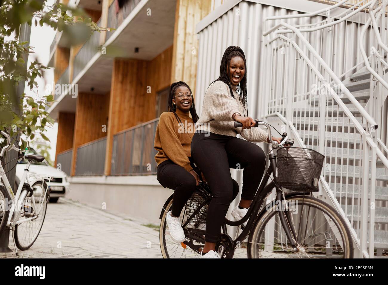 Happy female friends on bicycle Stock Photo - Alamy