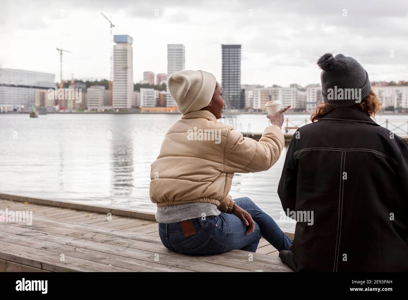 Female friends talking at sea Stock Photo - Alamy