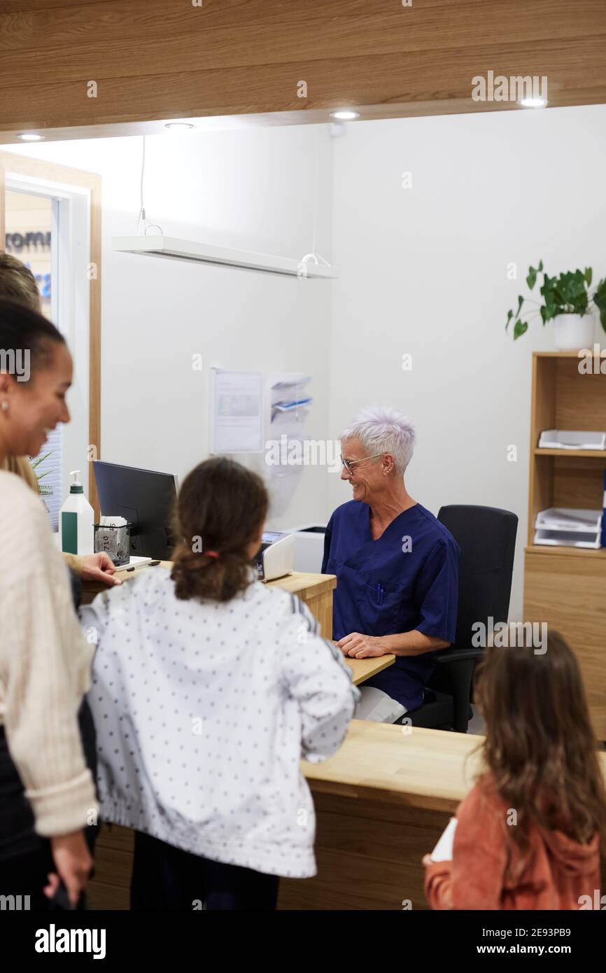 Family visiting doctor in health center Stock Photo - Alamy