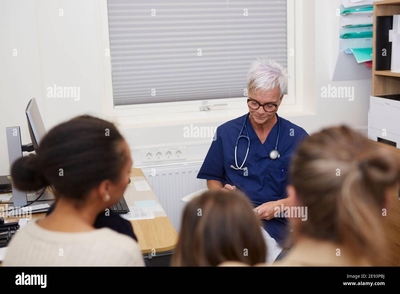 Family visiting doctor in health center Stock Photo - Alamy