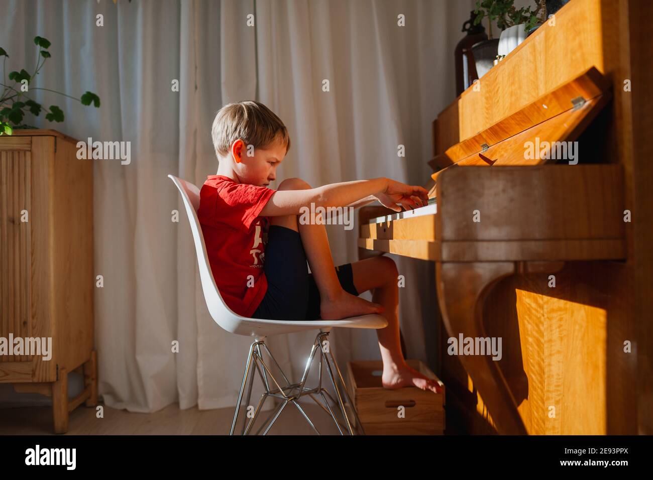 Boy playing piano Stock Photo - Alamy